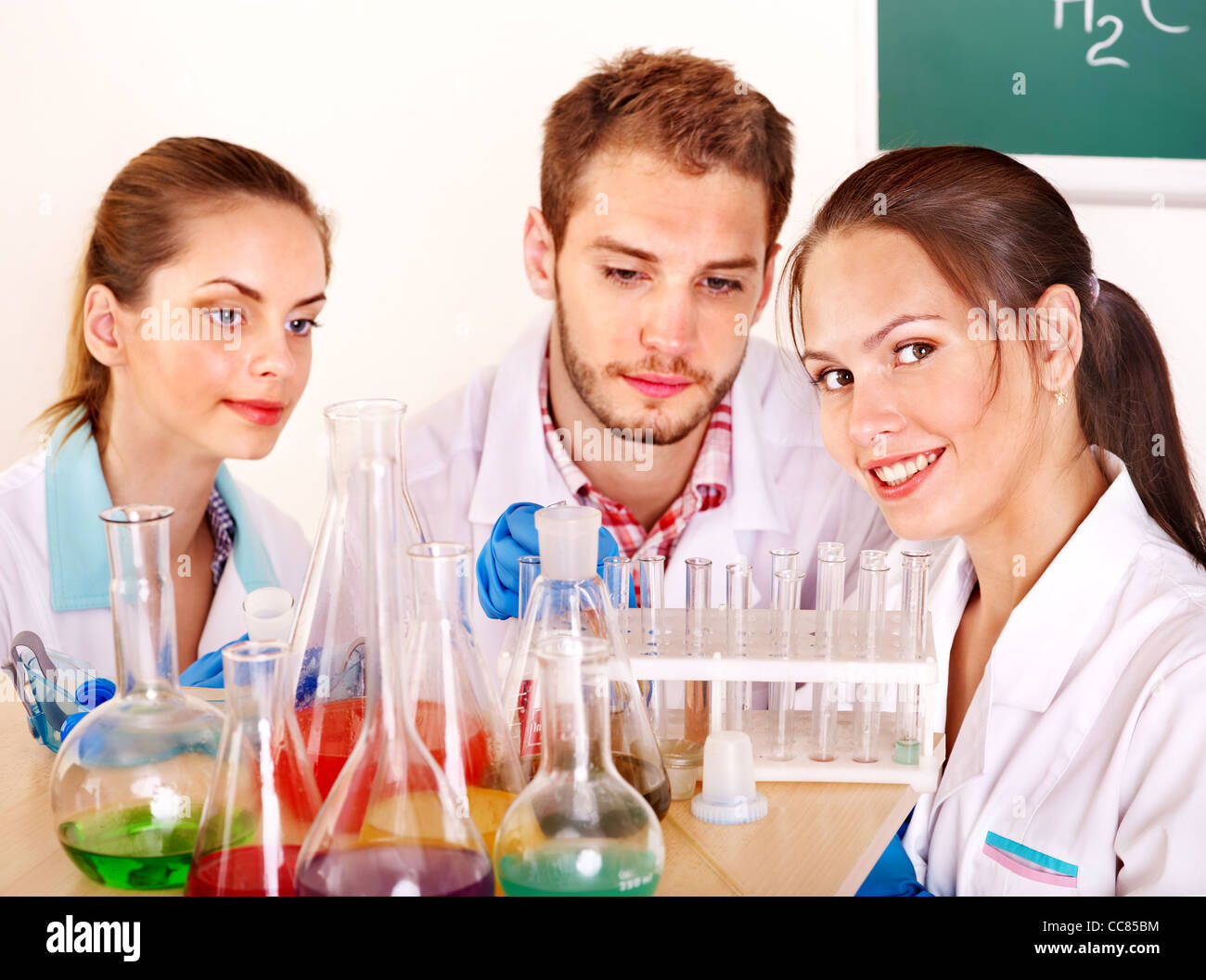 Group chemistry student with flask in classroom Stock Photo - Alamy