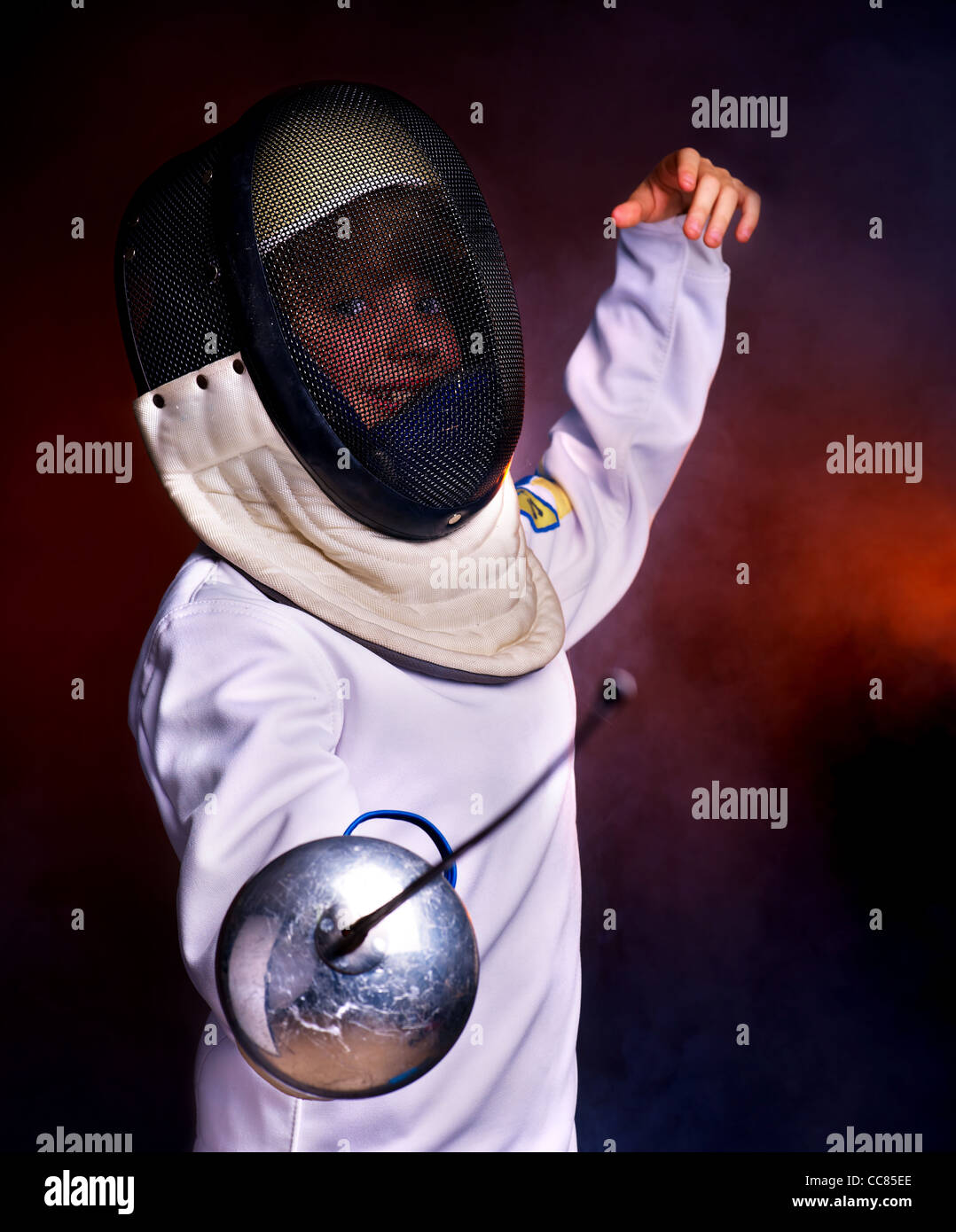 Child epee fencing lunge. Dark background Stock Photo - Alamy