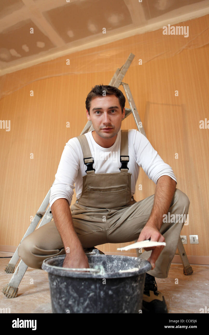 Man mixing plaster Stock Photo - Alamy