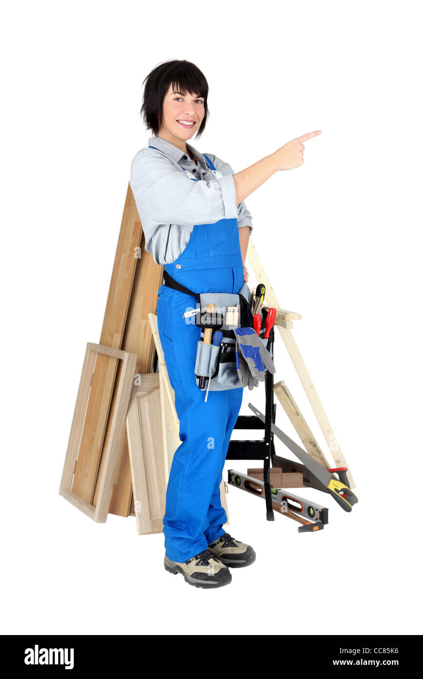 Smiling woman carpenter on white background Stock Photo - Alamy