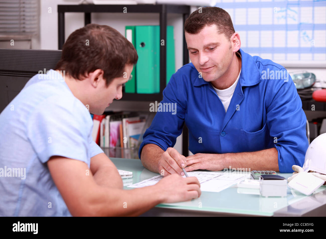 two men watching plans Stock Photo - Alamy