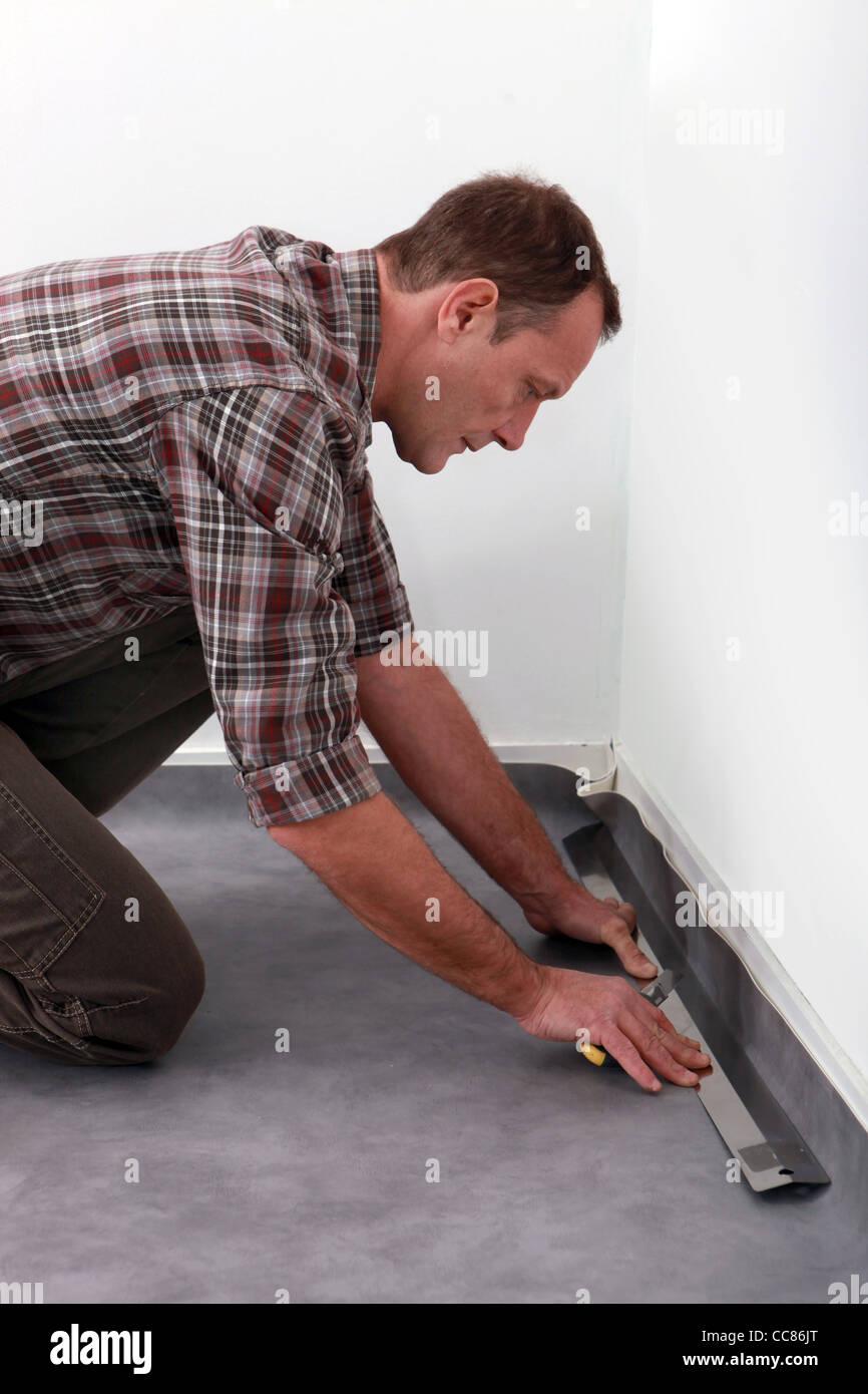 A man laying carpet Stock Photo - Alamy