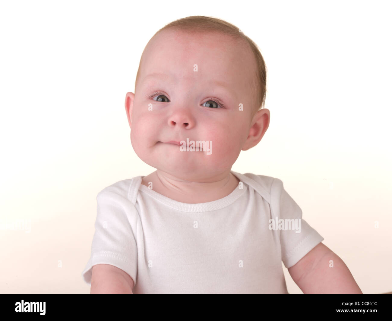 A happy baby girl looking attentive on a white background Stock Photo ...