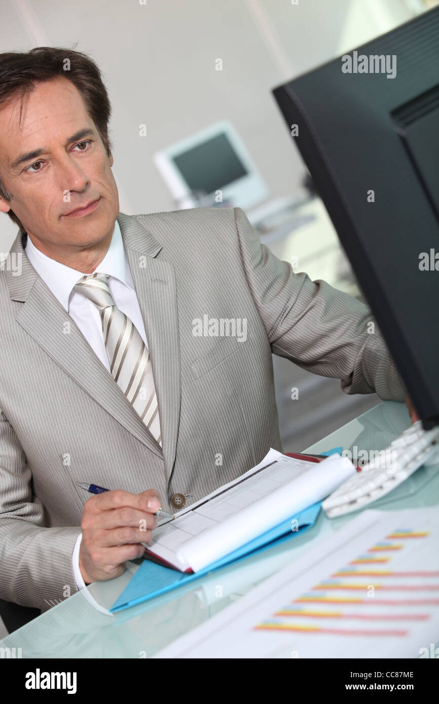 Executive working at computer Stock Photo - Alamy