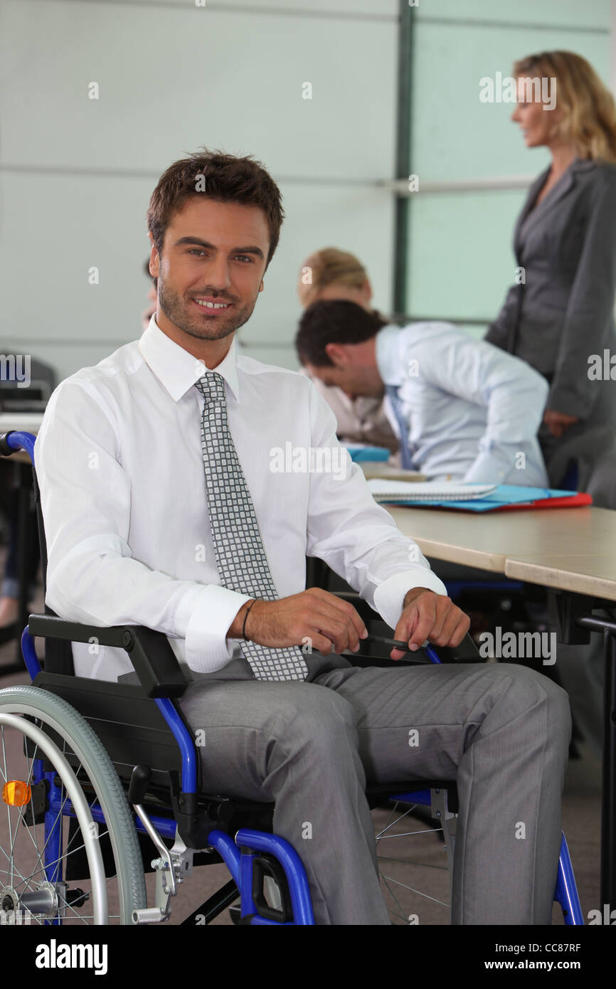 Man working in a wheelchair Stock Photo - Alamy