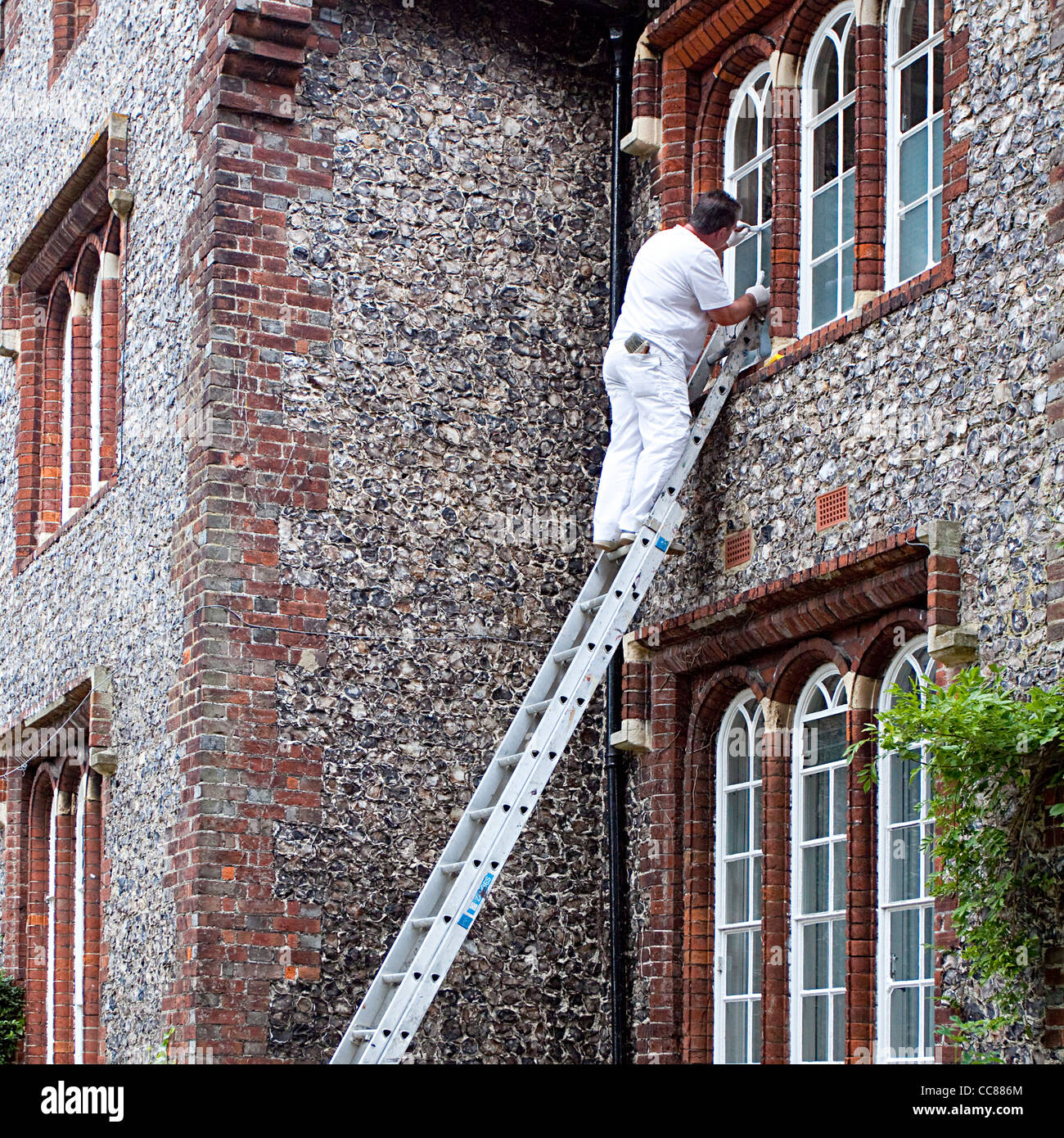 Painter decorator working on ladder hi-res stock photography and images ...