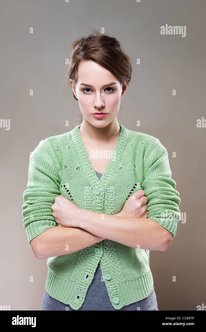 Half length portrait of an extremely aggressive looking young woman ...