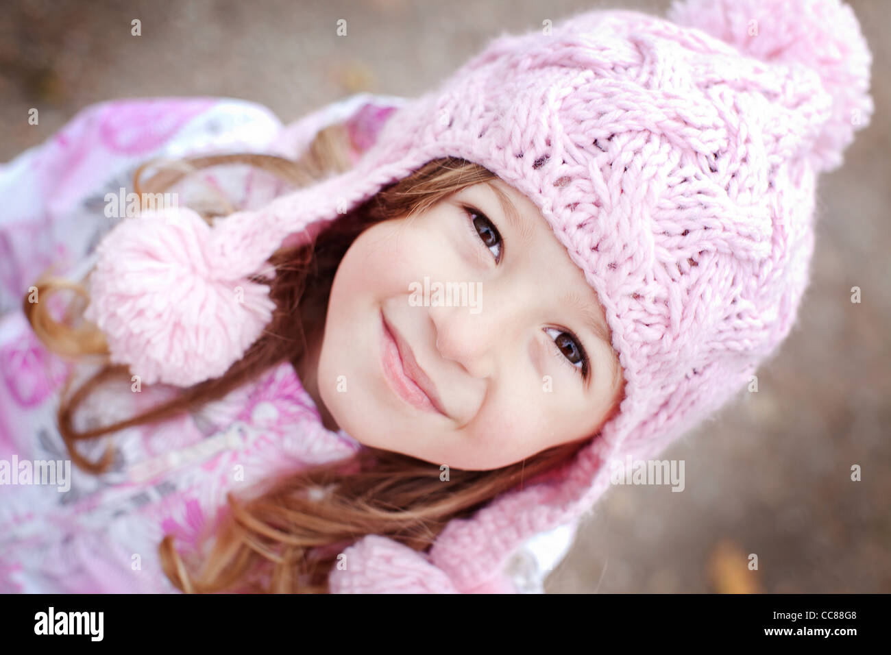 little happy girl in a pink wooly hat Stock Photo - Alamy