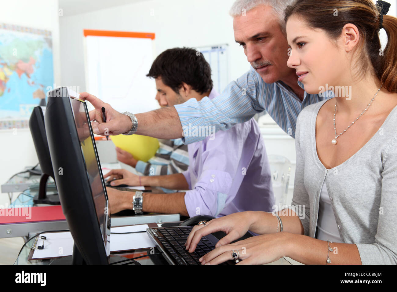 Mature students using computers in a classroom Stock Photo - Alamy