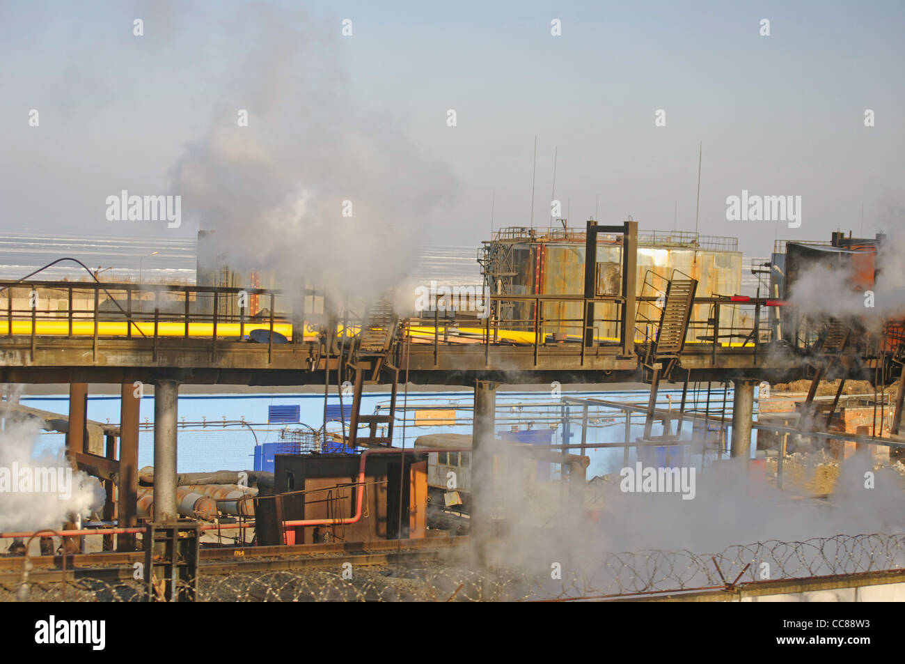 Detail of a factory with smoking chimney Stock Photo - Alamy