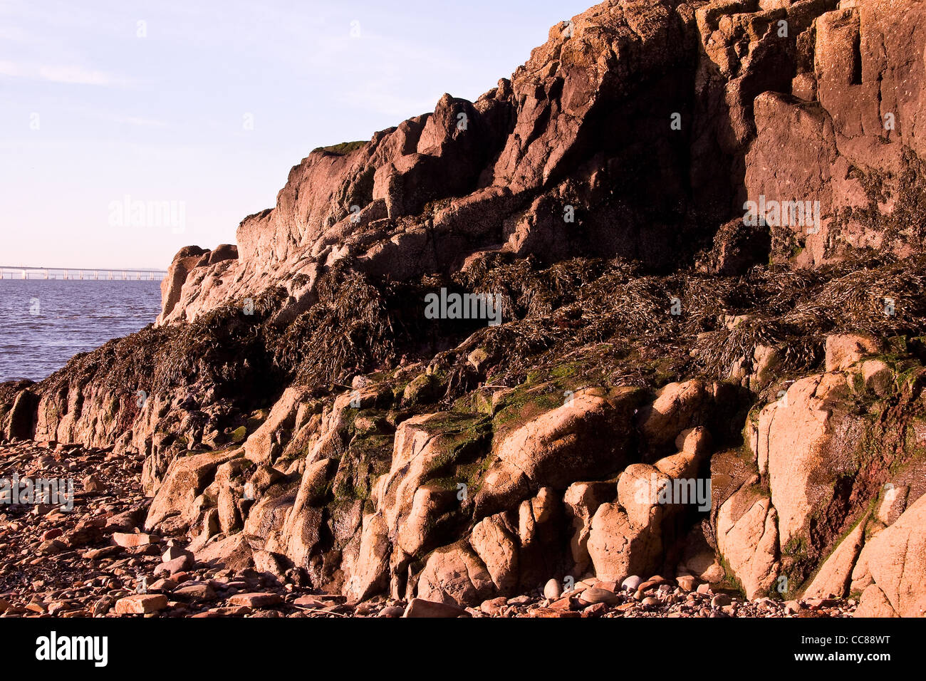 January sun shining on the rocks at the Broughty Ferry Beach along the ...
