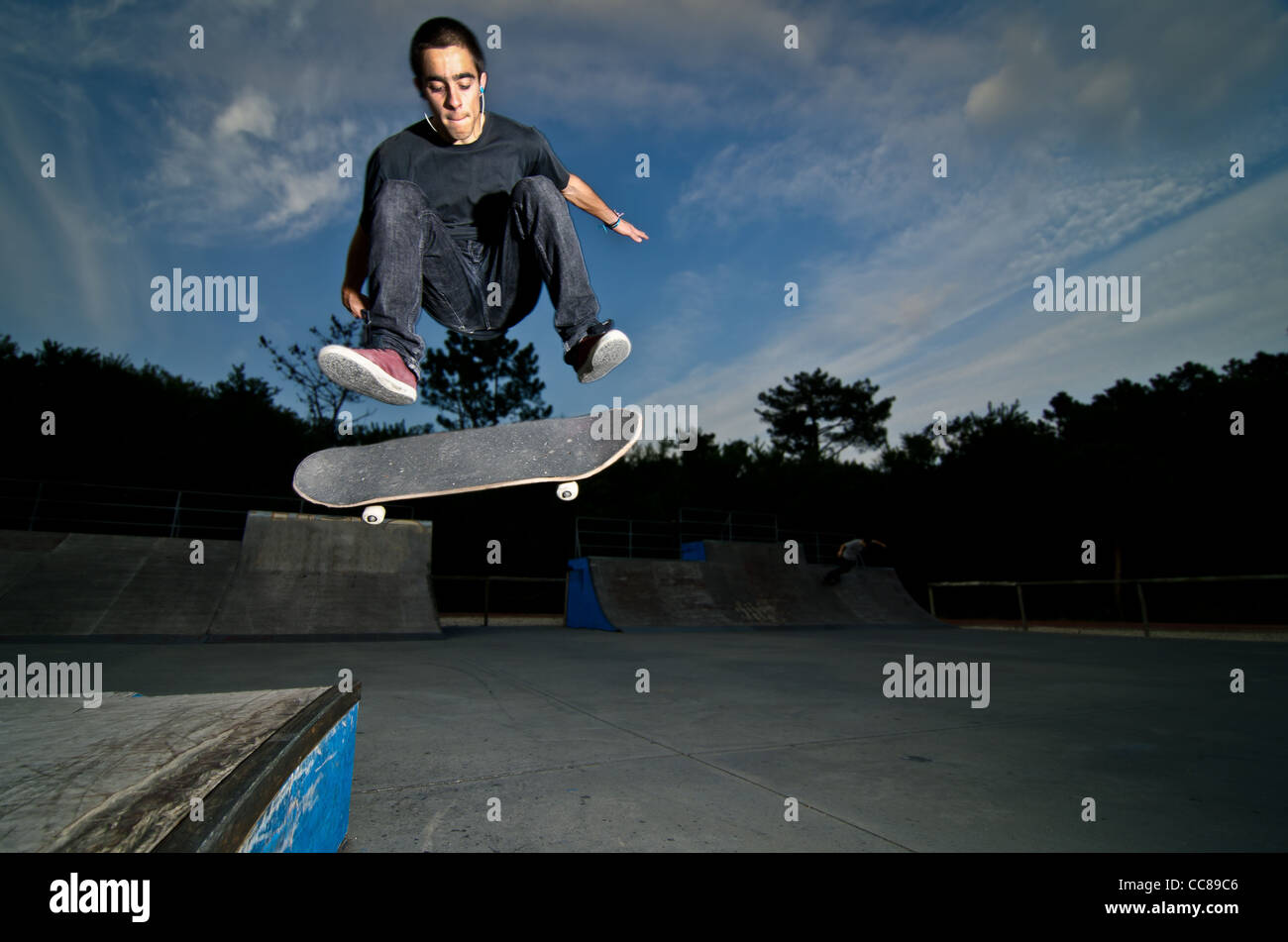 Skateboarder on a flip trick at the local skatepark Stock Photo - Alamy