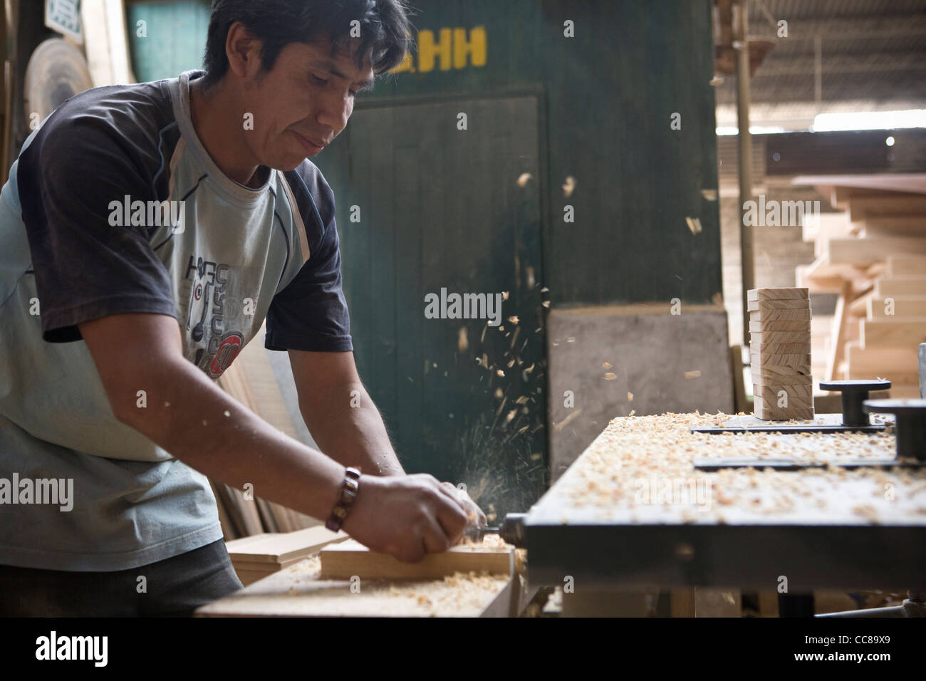 A carpenter works in a woodworking shop in Lima, Peru, South America ...