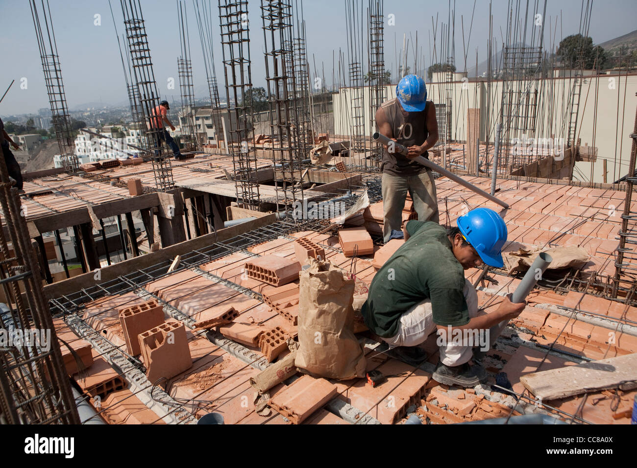 A work crew constructs a new high rise building in Lima, Peru, South ...