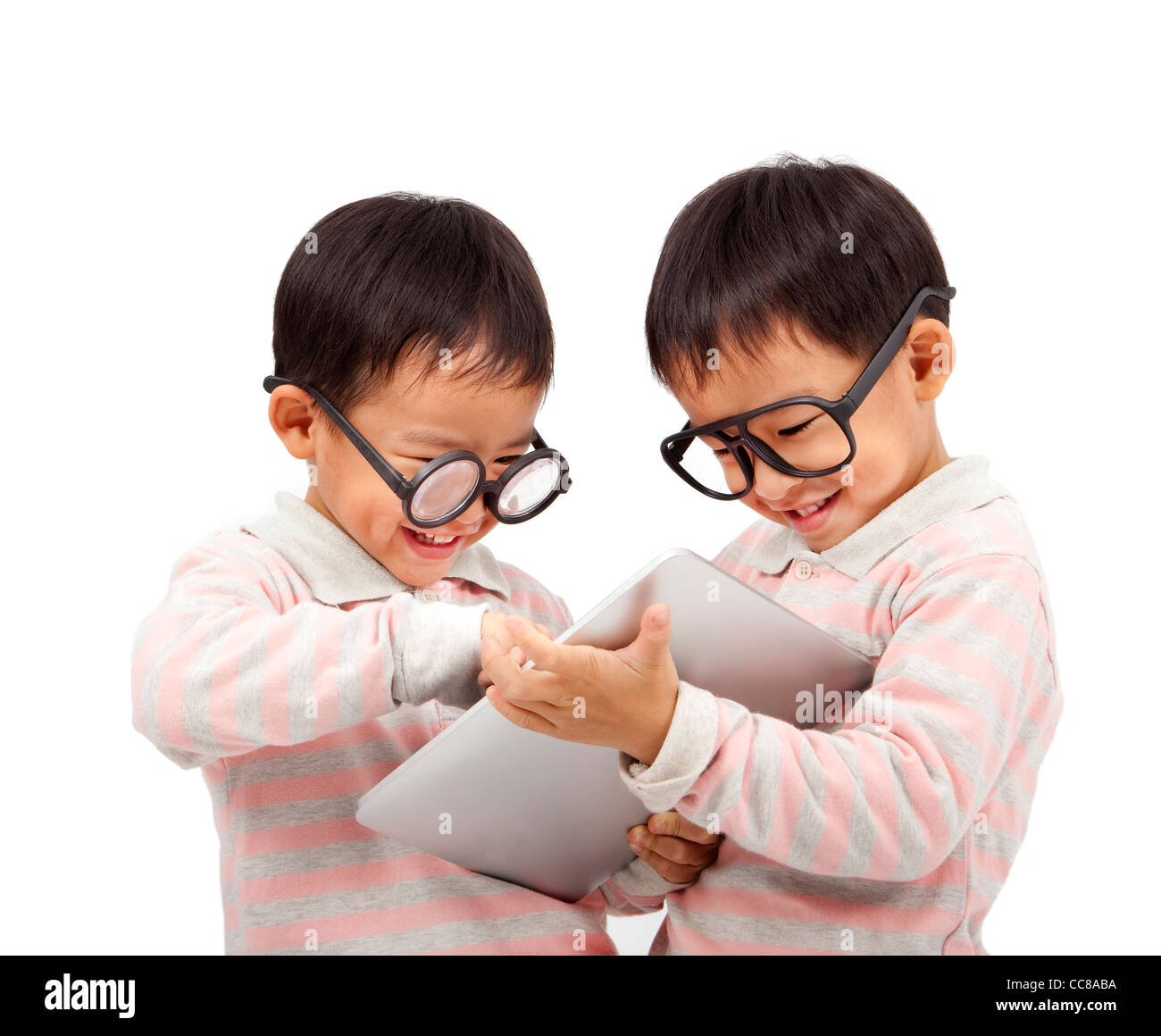 two happy kids using touch pad computer and isolated on white Stock ...