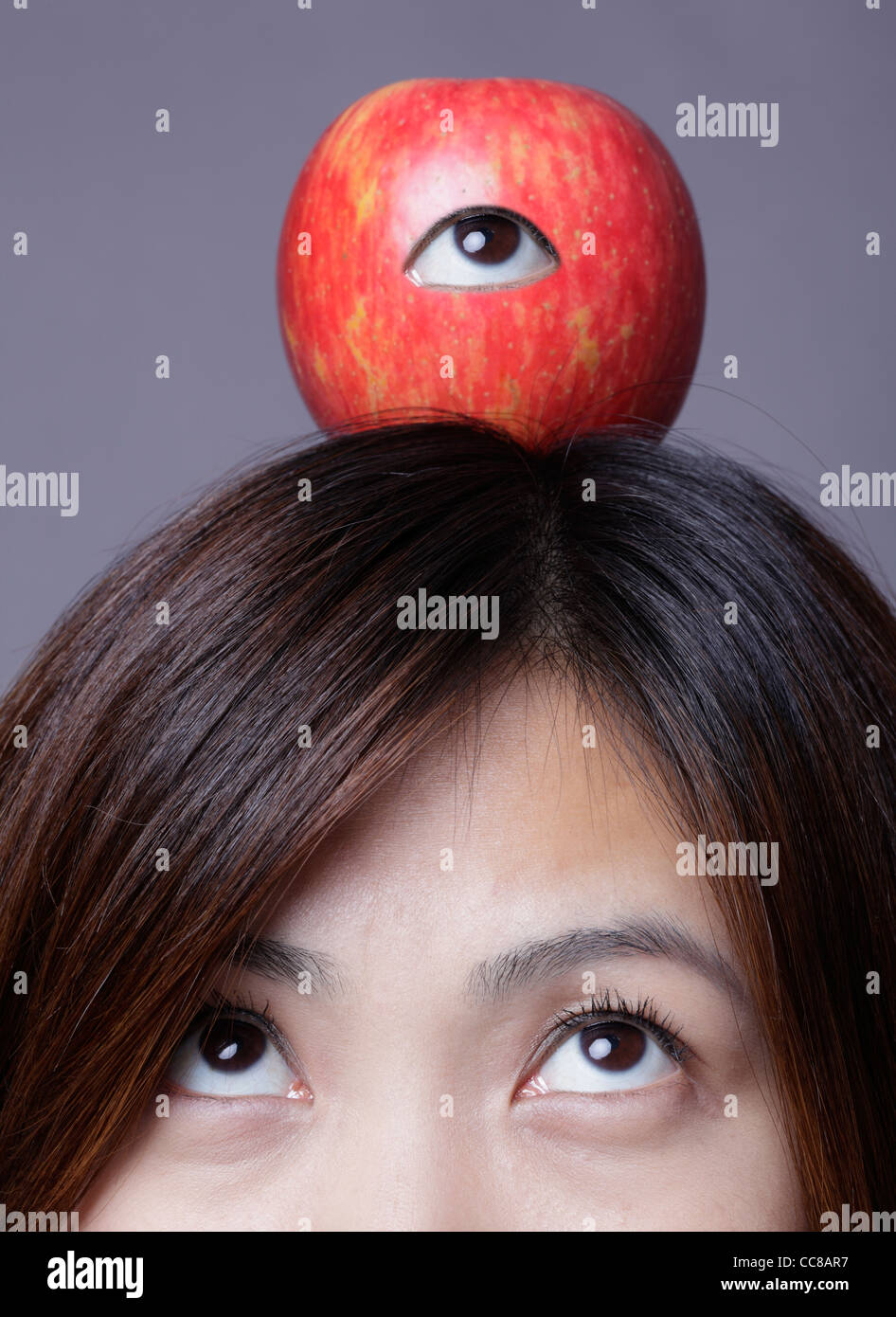 Office lady has apple on the top of head Stock Photo - Alamy