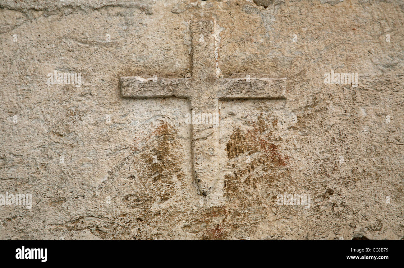 Cross on the wall Stock Photo - Alamy