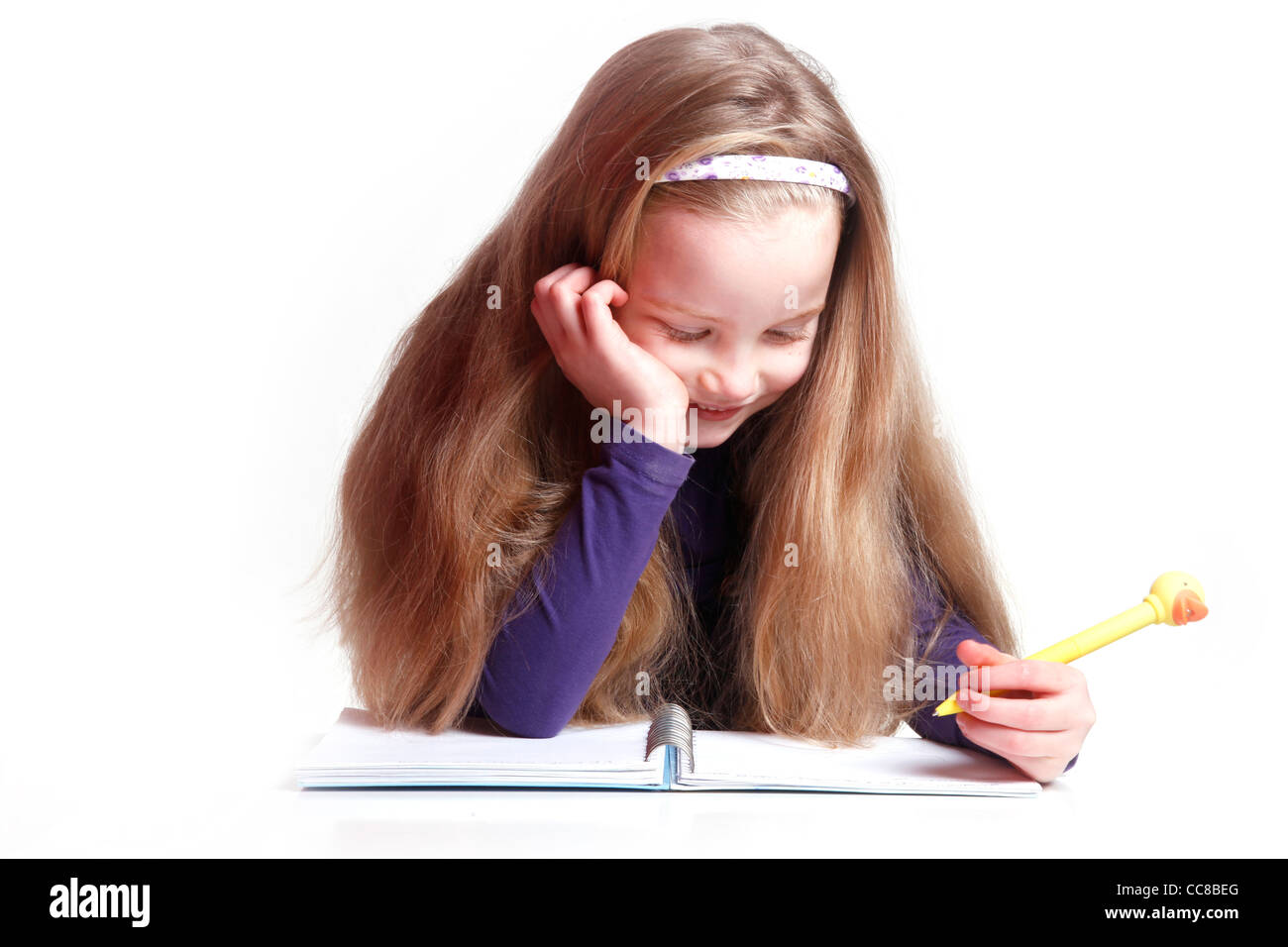 smiling young girl writing and white background Stock Photo - Alamy