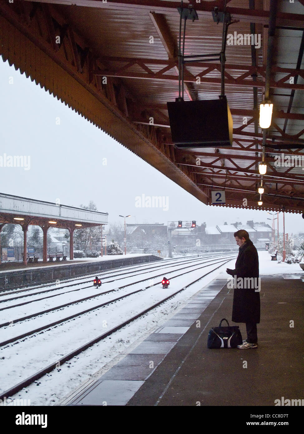 man on train station platform in snow Stock Photo - Alamy