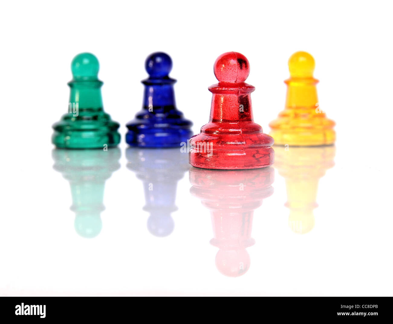 Multicolored ludo glass figures over white background Stock Photo - Alamy