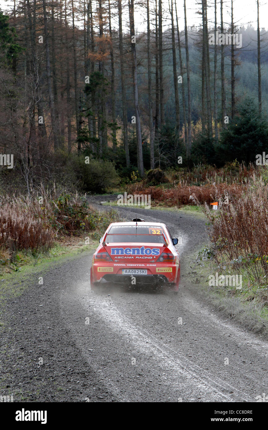 gravel sprays from a rally cars wheels as it passes Stock Photo - Alamy