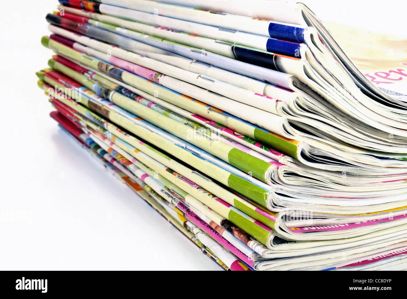 Pile of multicolored magazines over white background Stock Photo - Alamy