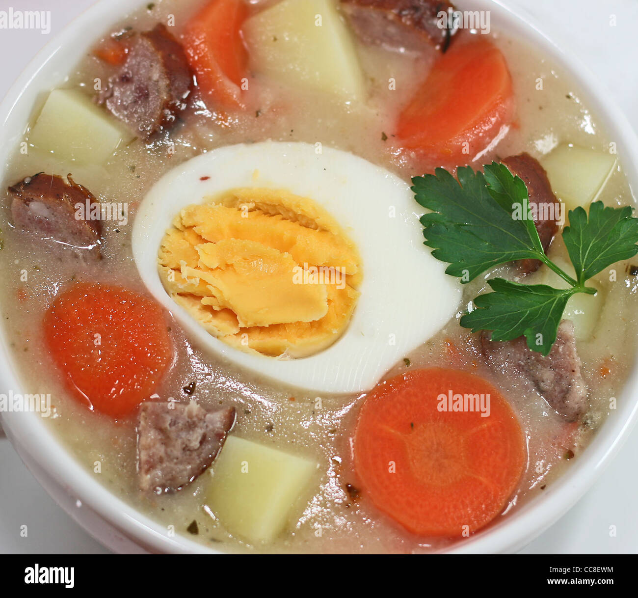 Traditional polish white borscht with eggs and sausage in white ...