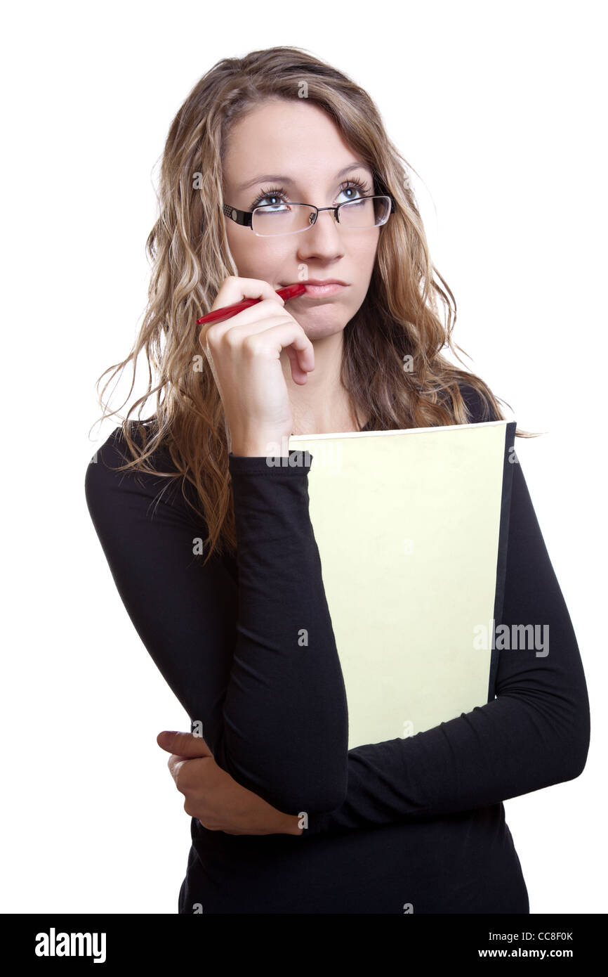 Young student with a pen and notebook thinking Stock Photo - Alamy