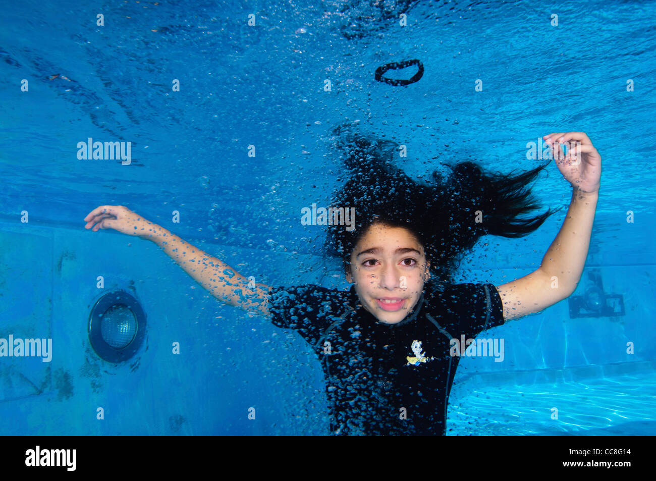 Young Girl Of 9 Holds Her Breath While Floating Underwater In A