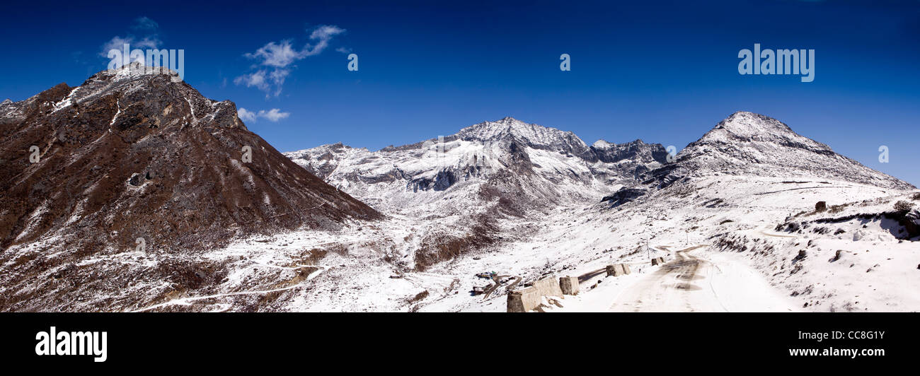 India, Arunachal Pradesh, snow capped mountains surrounding road ...