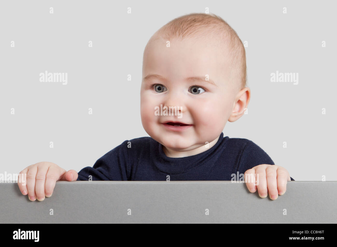 young child holding sign. isolate on grey background Stock Photo - Alamy