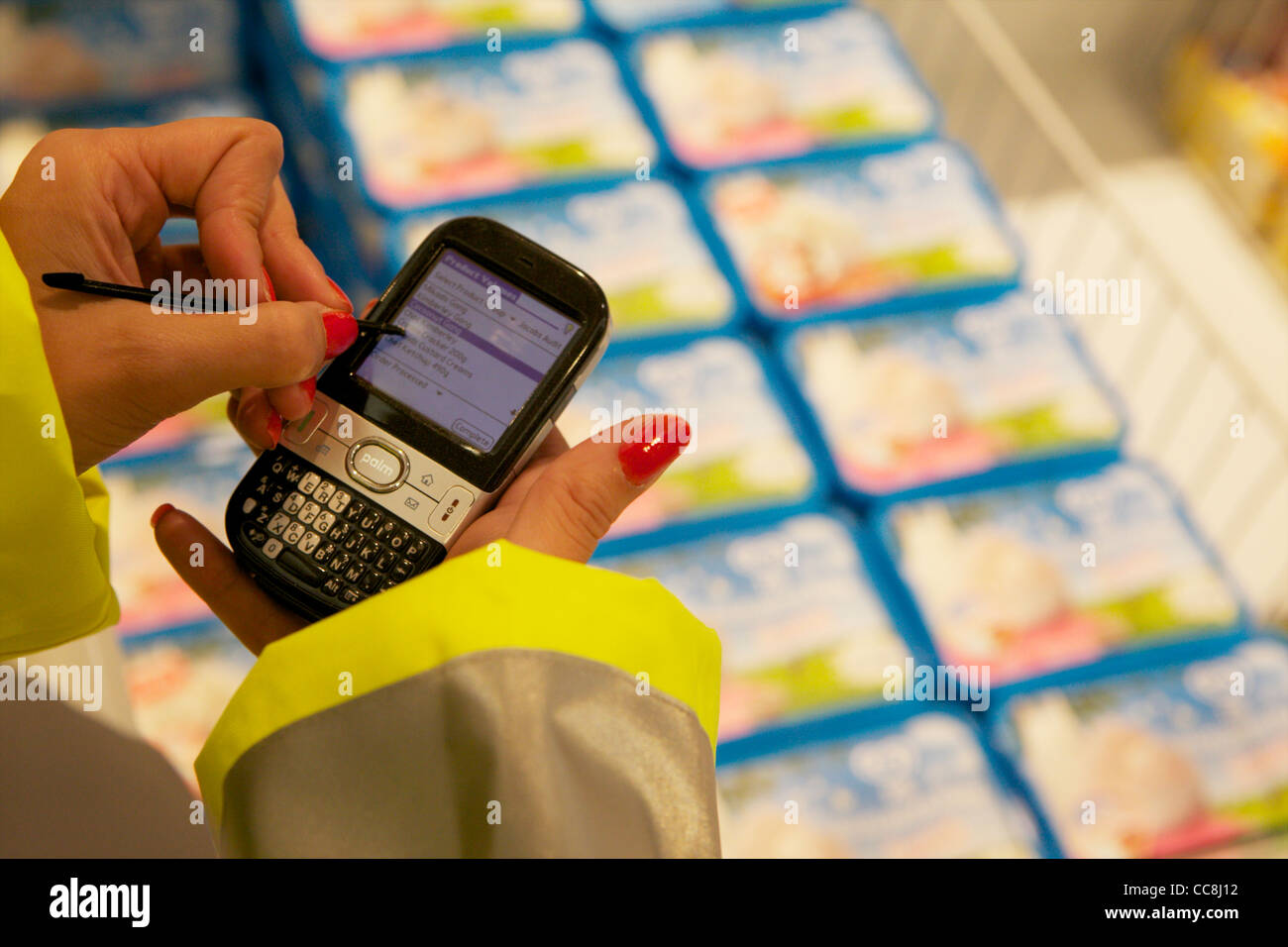 A handheld device doing an in store audit on products on sale Stock ...