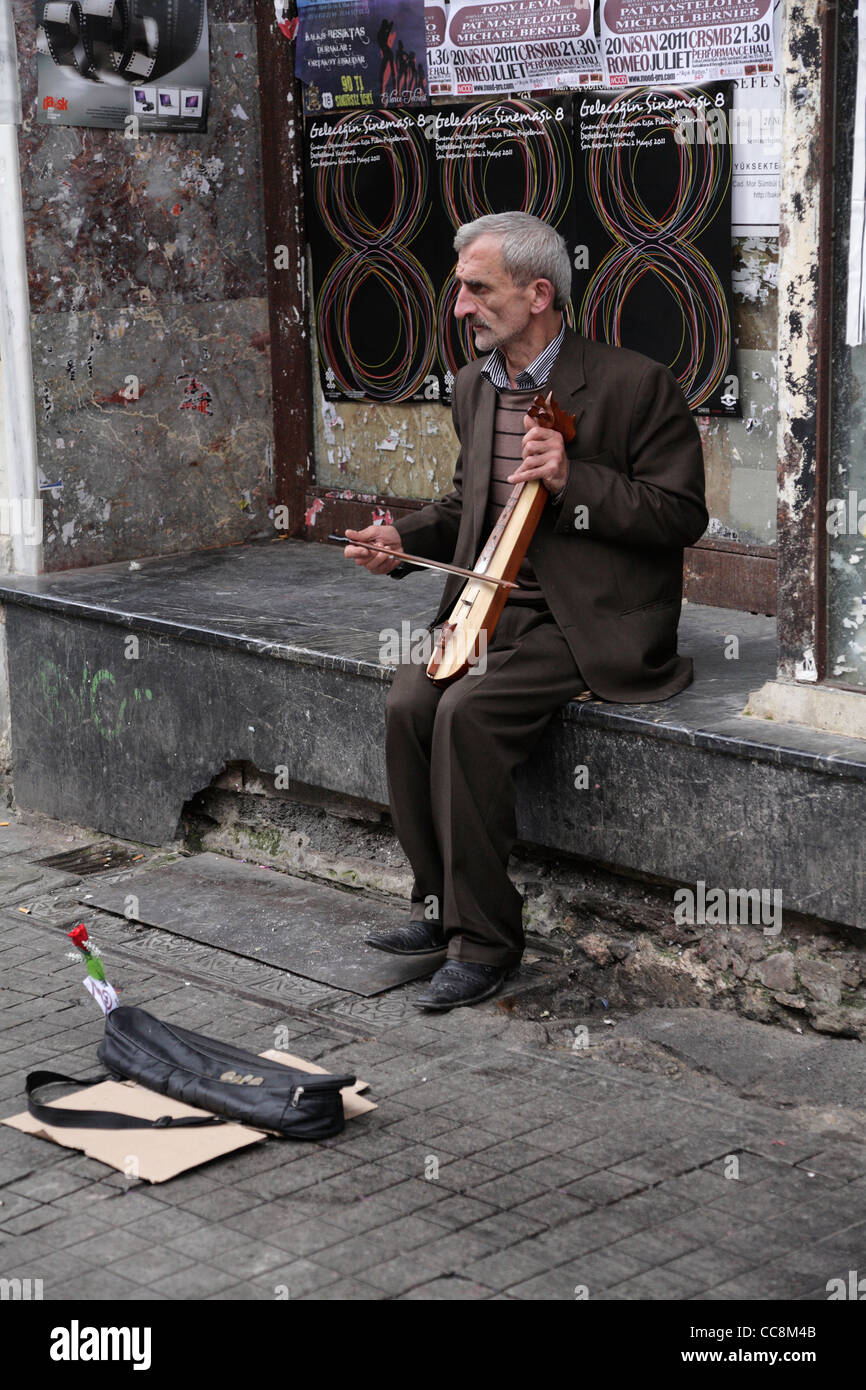 Street musician playing bowed fiddle old man, busker playing ...