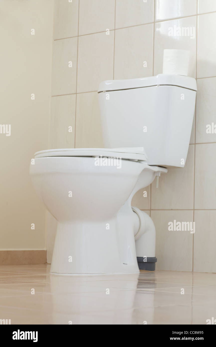 Clean and white toilet in a bathroom Stock Photo - Alamy