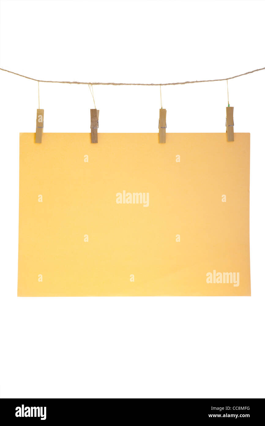 Orange blank paper sheet on a clothes line. Isolated on white ...