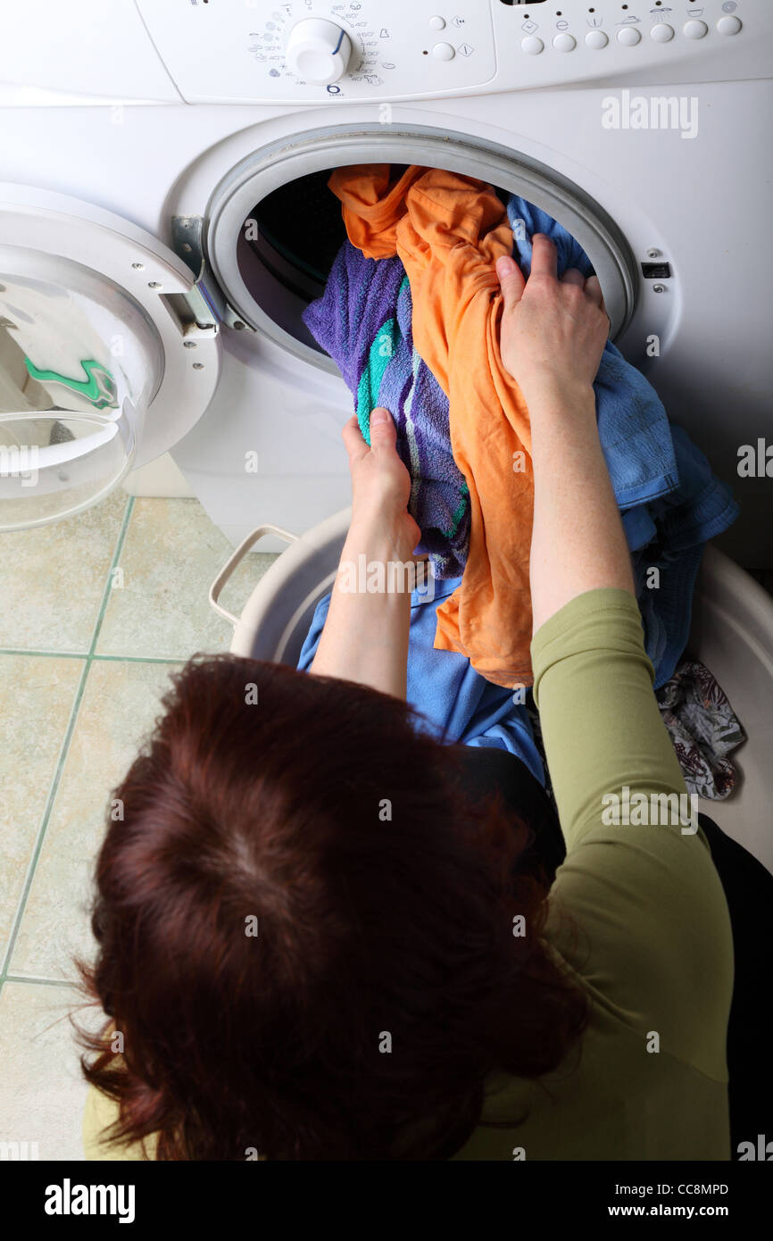 woman loading Preparation washing machine in bathroom clothes in the ...