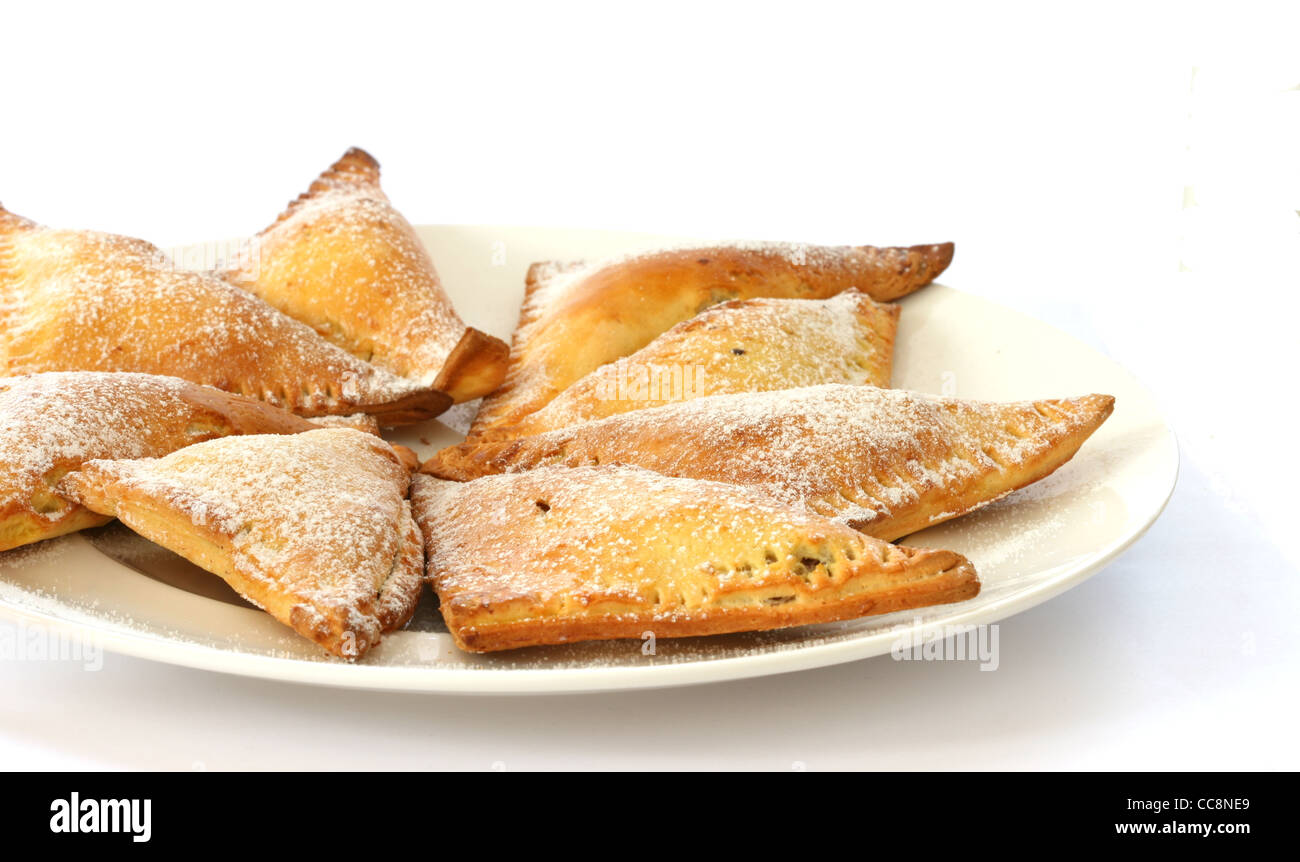 Sweet baked pastry triangles on white plate Stock Photo - Alamy