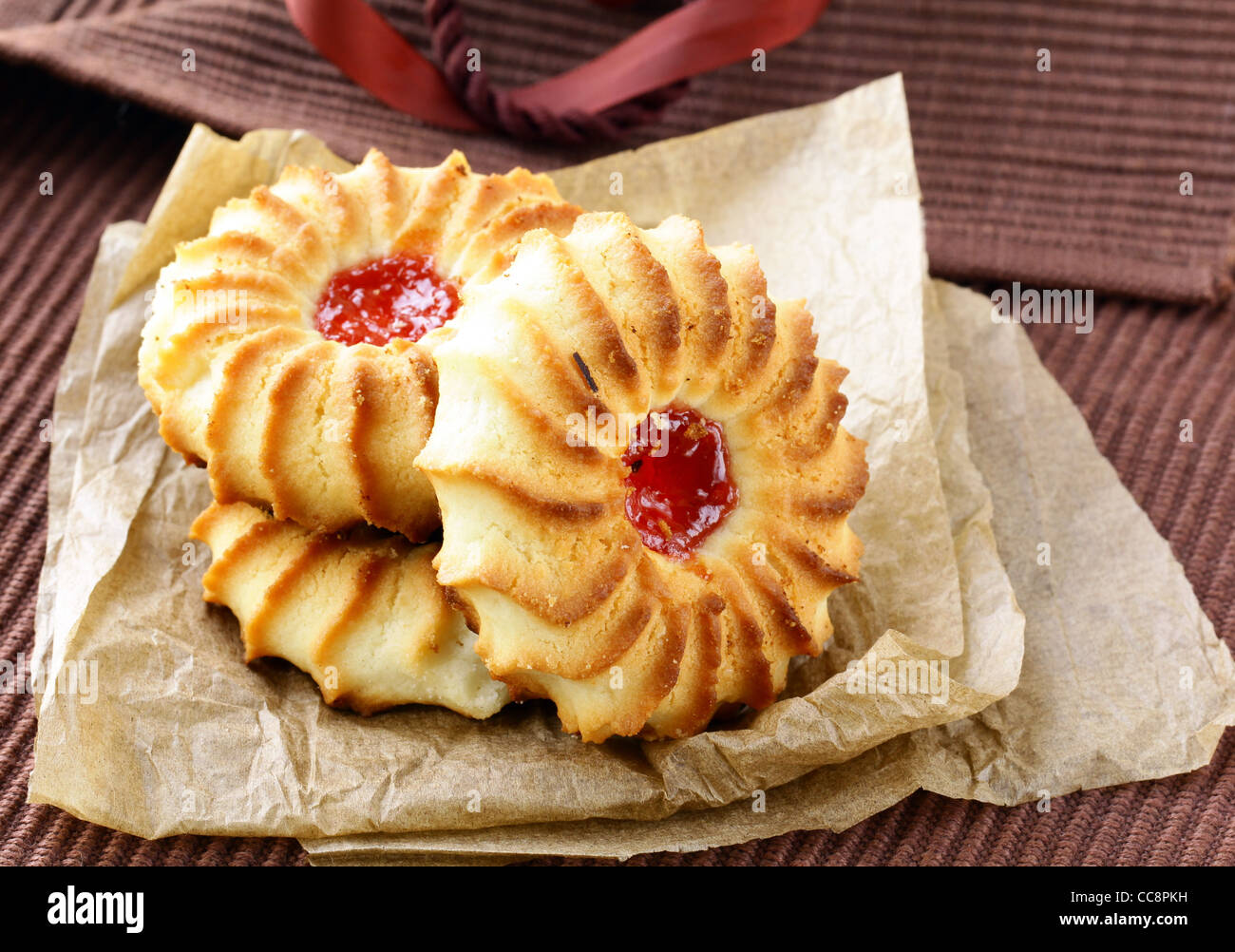 beautiful cookies with jam on a brown background Stock Photo - Alamy