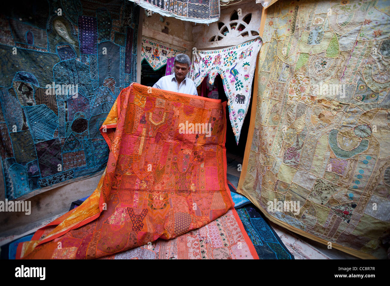 Carpet and textile merchant seller showing off his wares in Jaisalmer ...