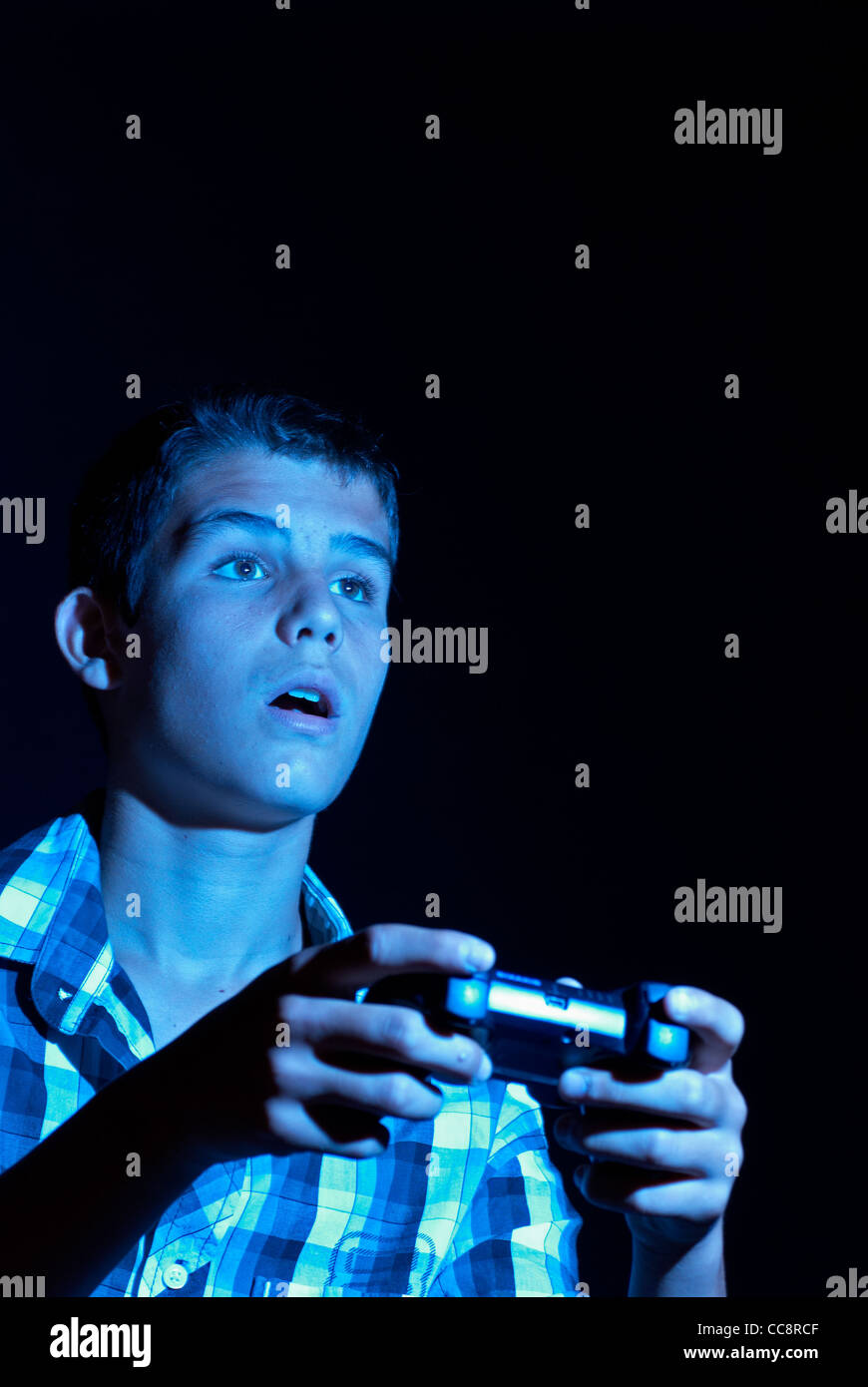 Teen with deranged facial expression while passionately gaming Stock ...