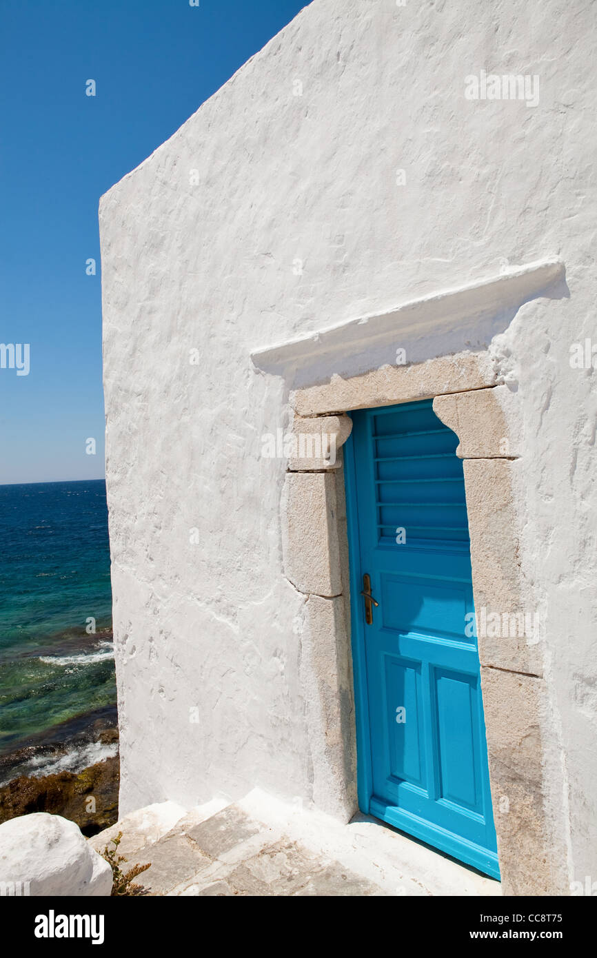 Blue wooden door on a white wall with blue sky, in Mykonos, Greece ...