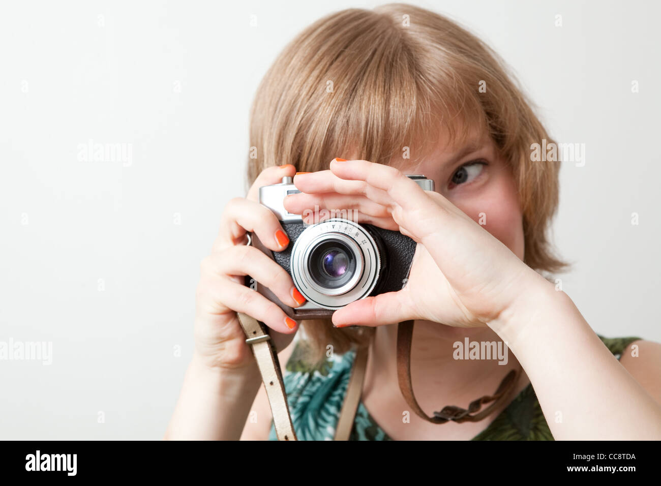 Young woman holding an old vintage camera Stock Photo - Alamy