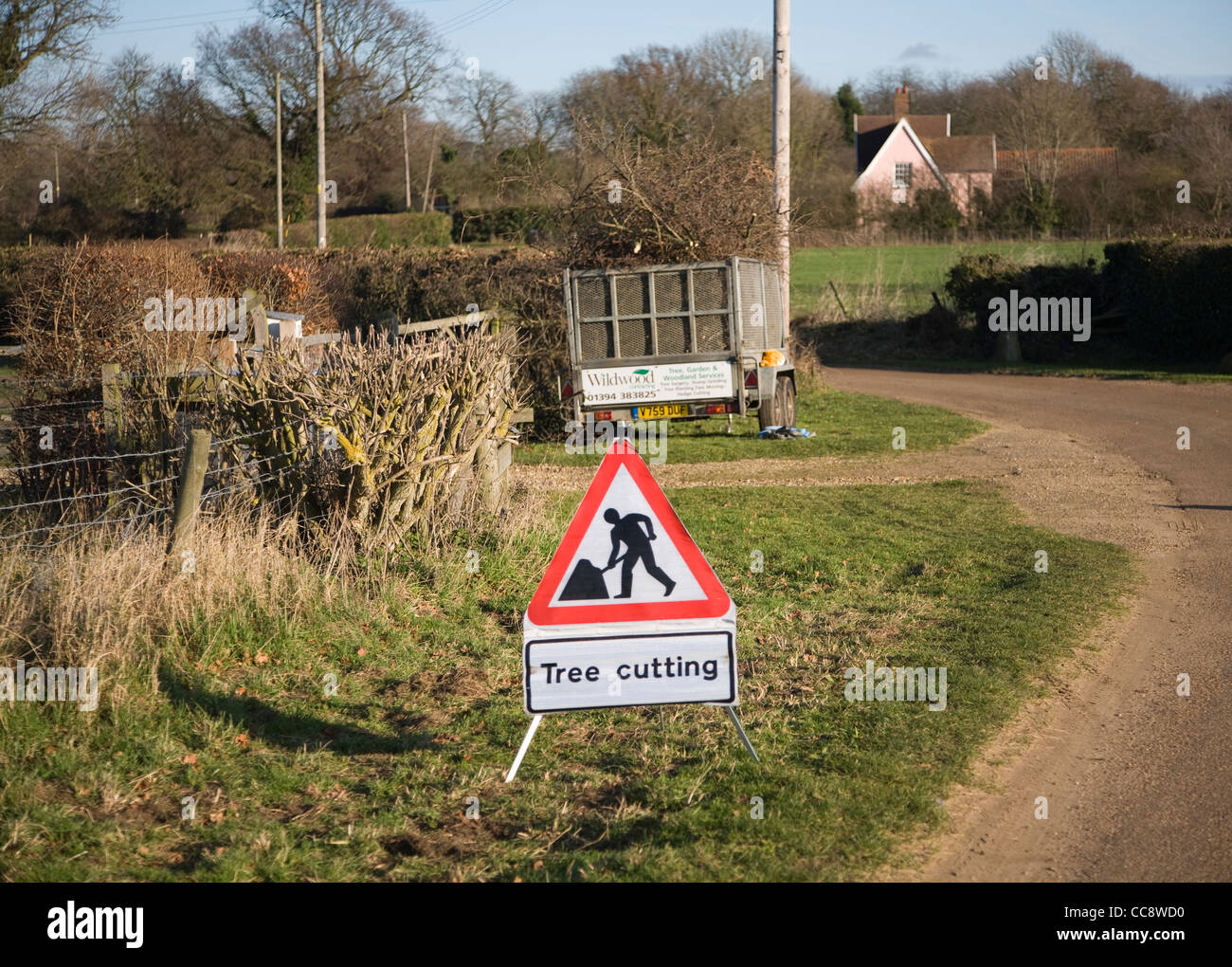 Tree cutting sign red triangle man at work Stock Photo - Alamy