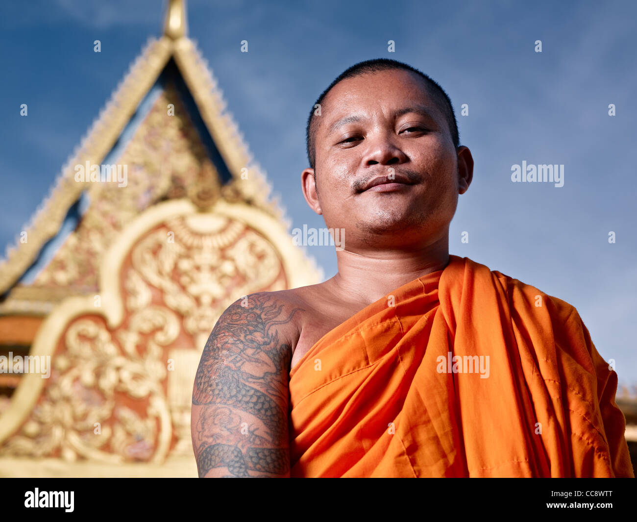 Mid adult Asian monk smiling at camera in buddhist monastery, Phnom ...
