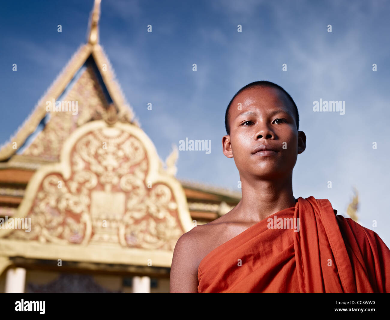 Young Asian monk smiling at camera in buddhist monastery, Phnom Penh ...
