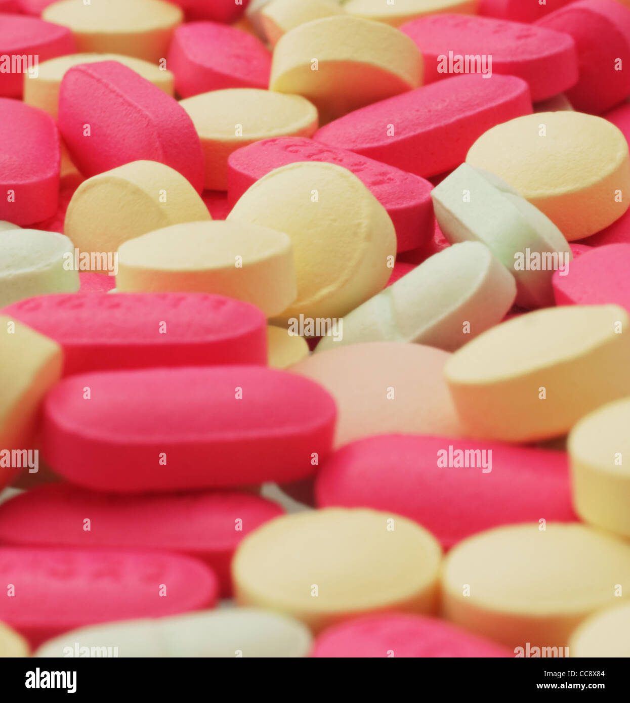 brightly colored pills Stock Photo - Alamy