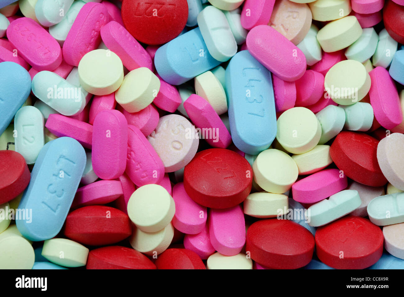 brightly colored pills Stock Photo - Alamy