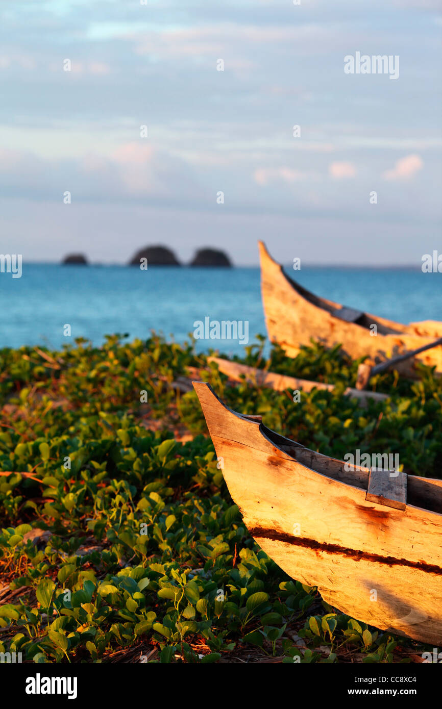 Two beached outrigger dugout canoes, or pirogues, malagasy sailing ...