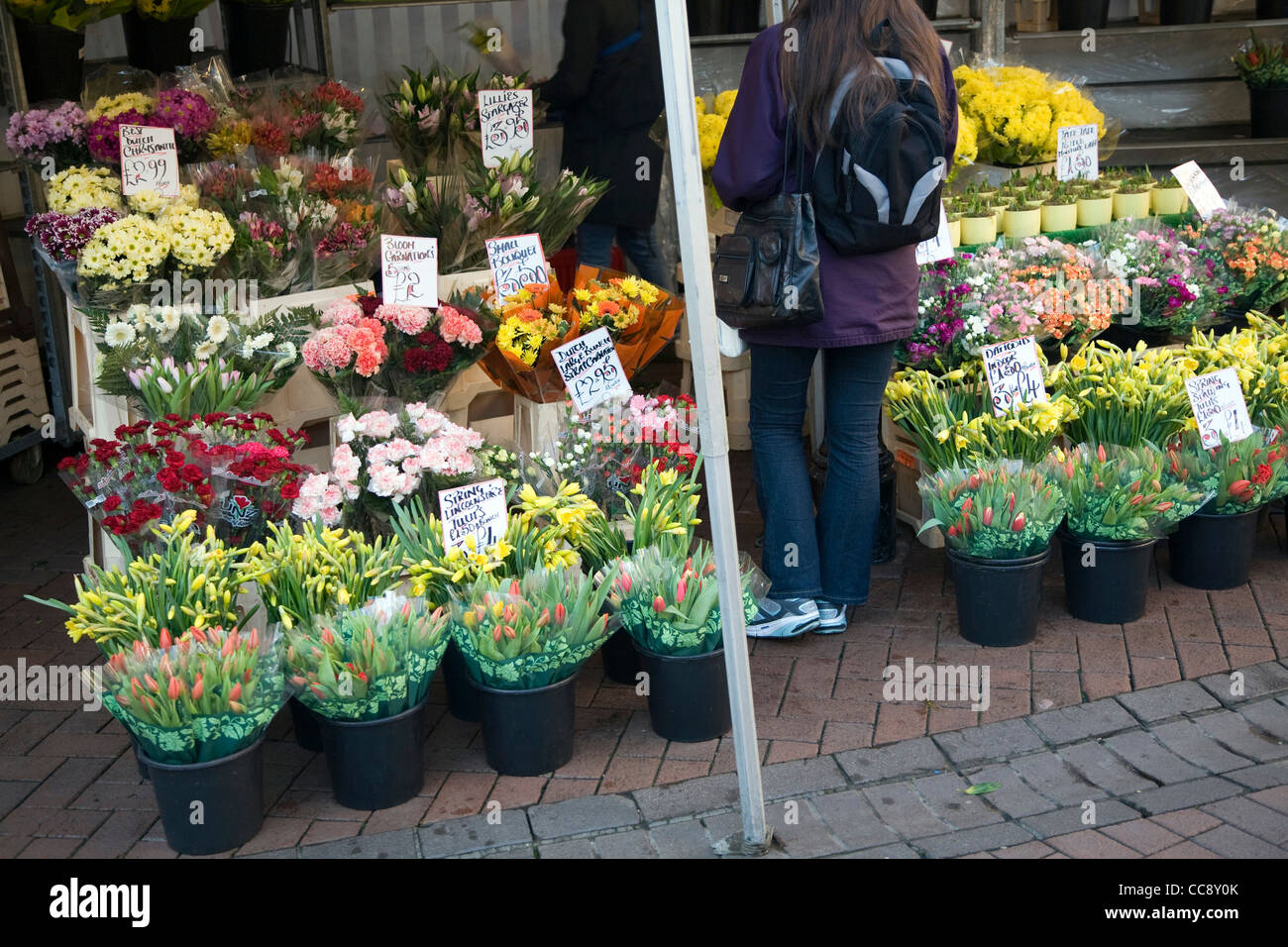 Bunches fresh flowers in buckets market stall Stock Photo - Alamy