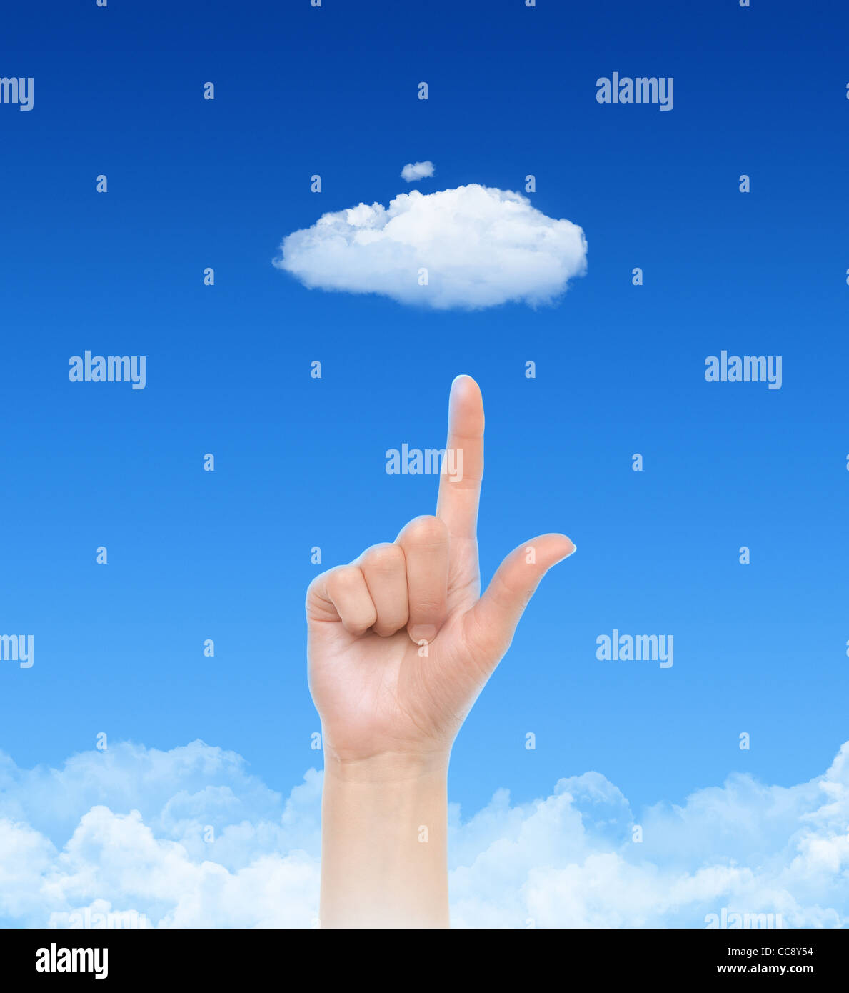 Woman hand point on cloud against blue sky with clouds. Concept image ...